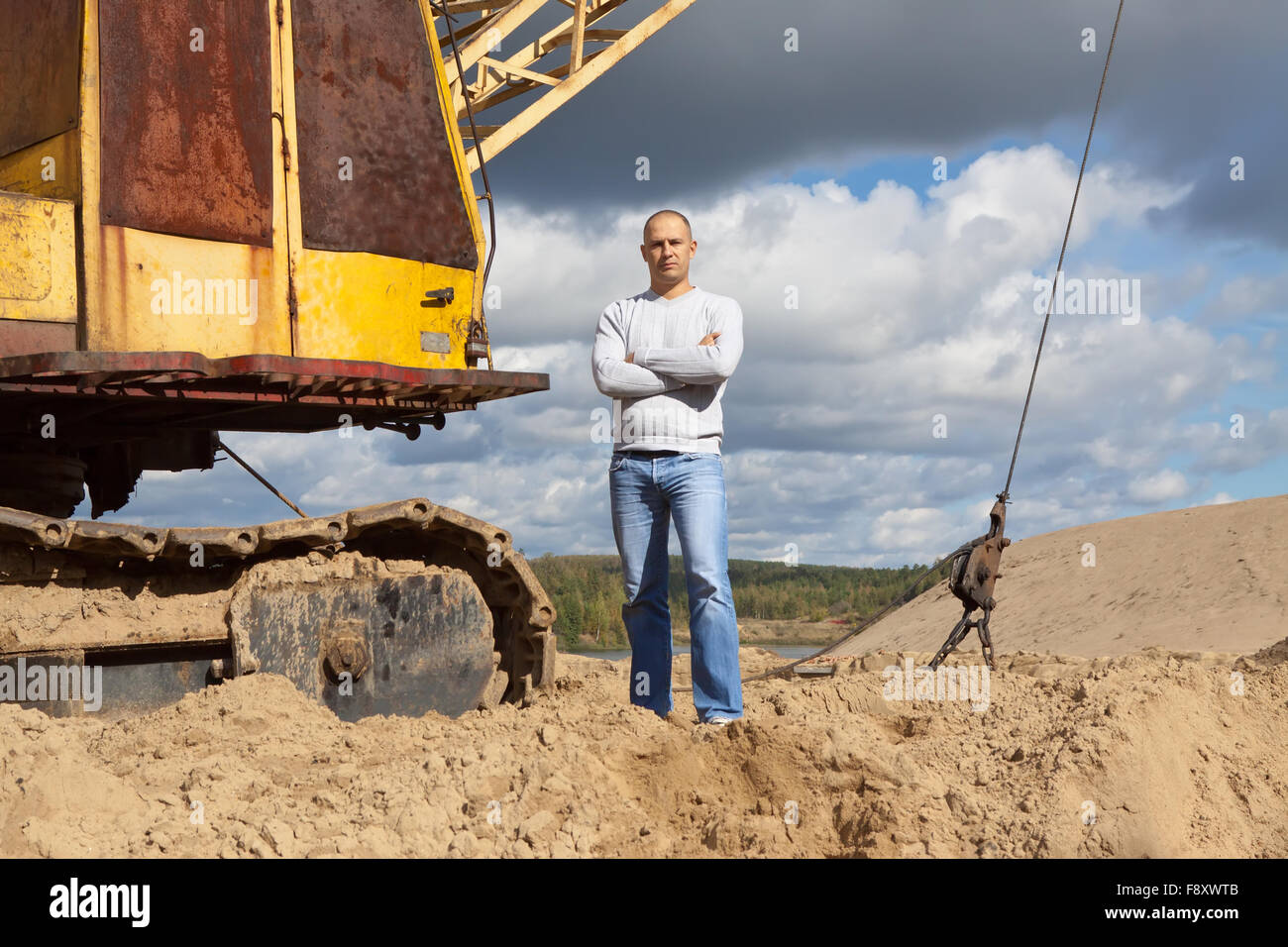 Portrait of tractor operator at sand pit Stock Photo - Alamy
