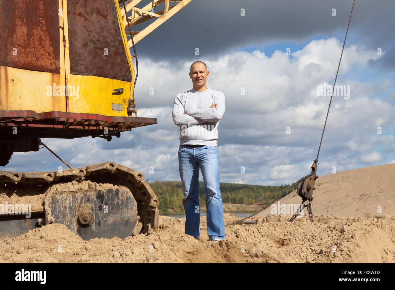 Portrait of tractor operator at sand pit Stock Photo - Alamy