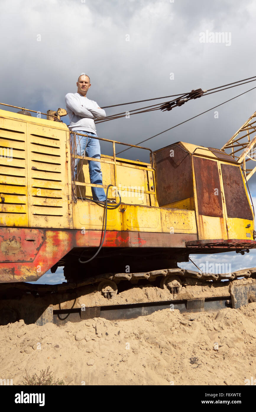 Portrait of tractor operator at sand pit Stock Photo - Alamy