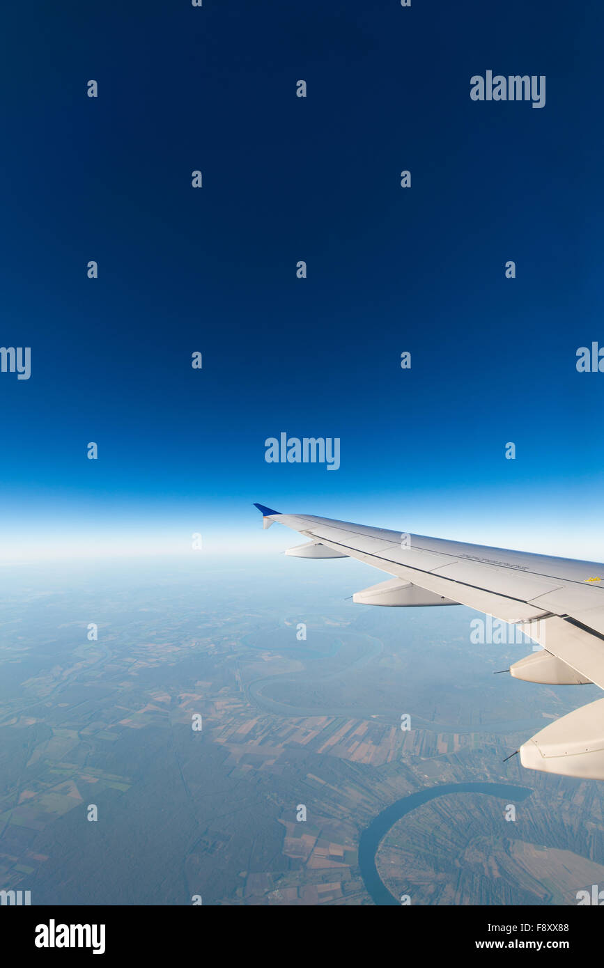 Airplane wing out of window Stock Photo - Alamy