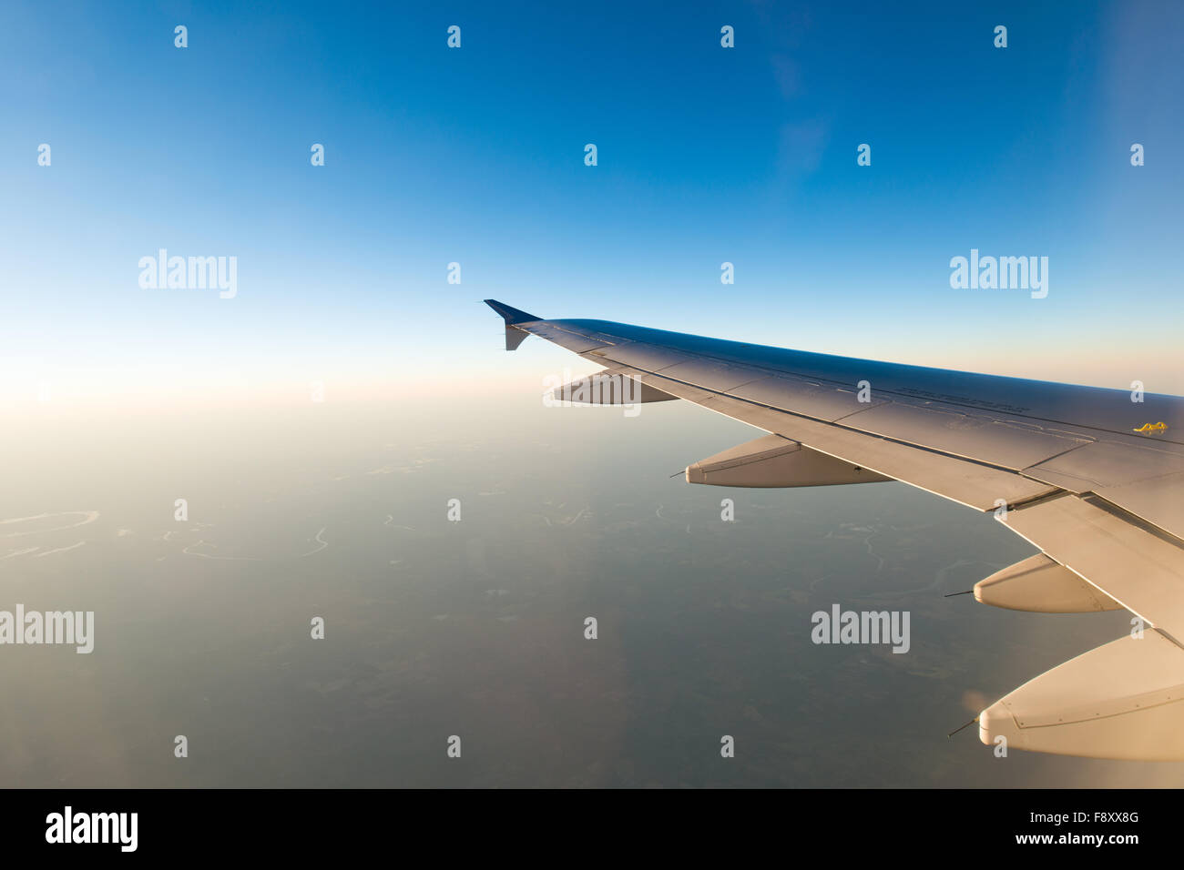 Airplane wing out of window Stock Photo - Alamy