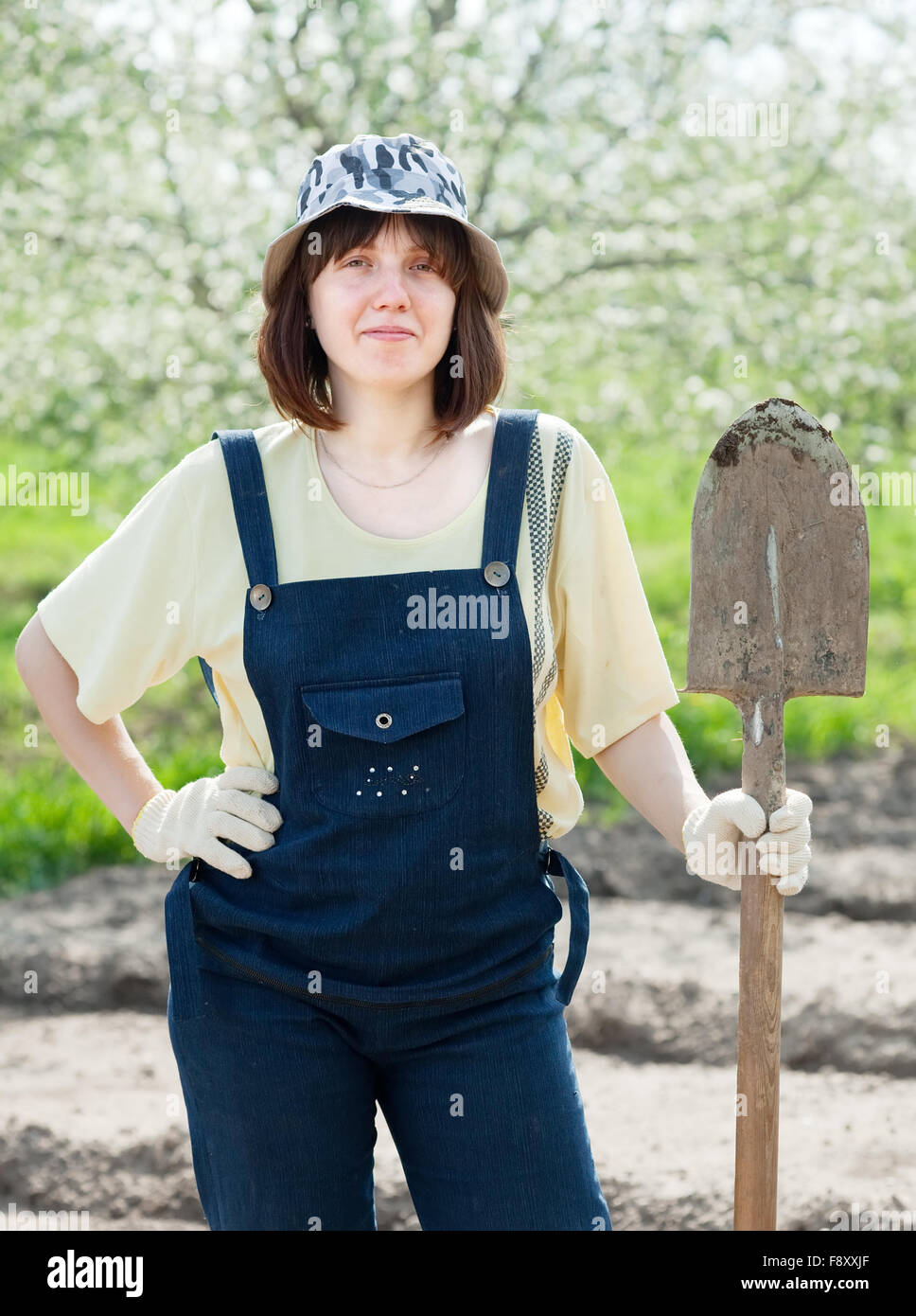 Female gardener with spade in spring Stock Photo - Alamy