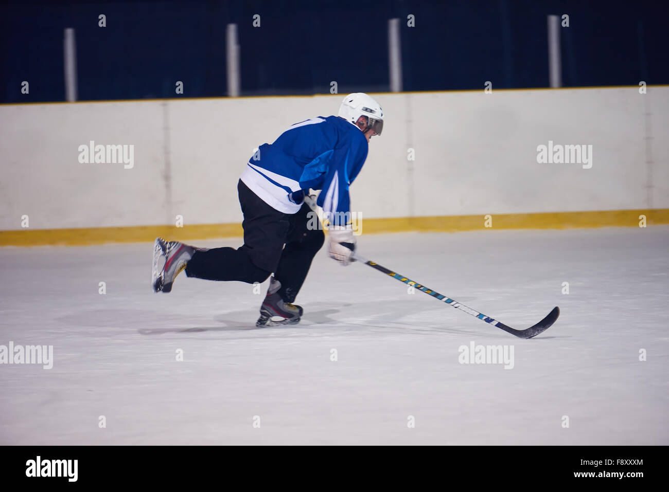 ice hockey player in action kicking with stick Stock Photo - Alamy