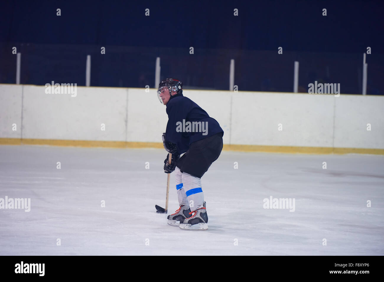 ice hockey player in action kicking with stick Stock Photo - Alamy