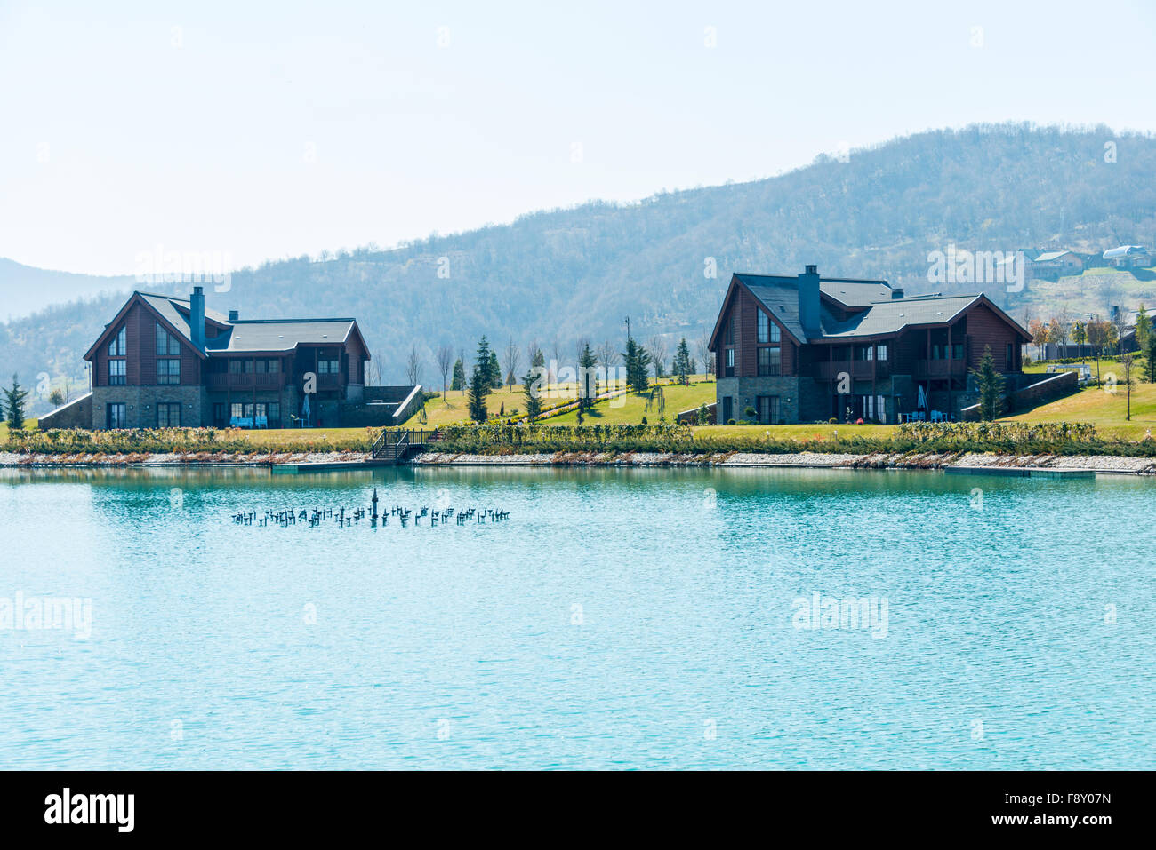 Modern house near water on bright day Stock Photo - Alamy