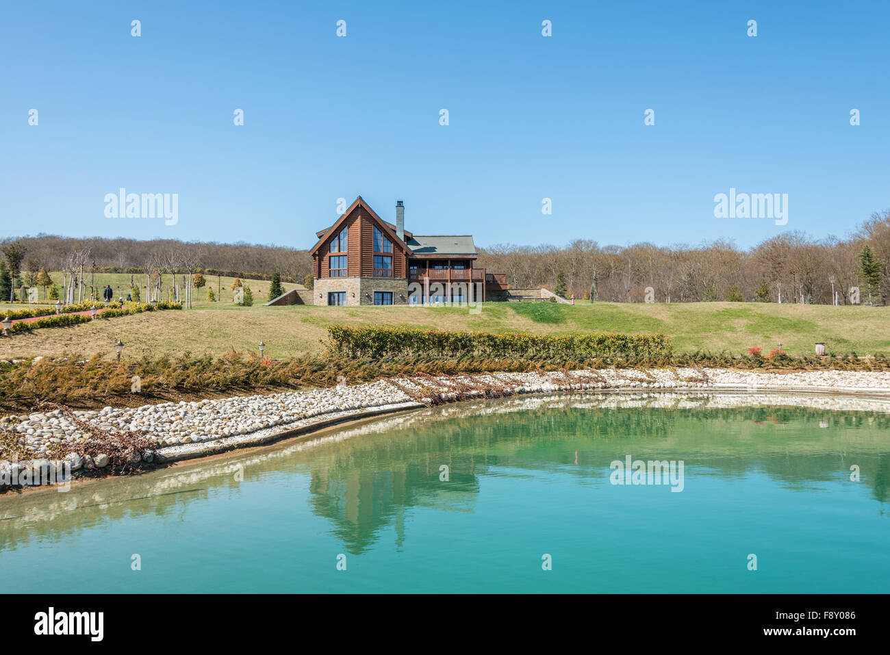 Modern house near water on bright day Stock Photo - Alamy
