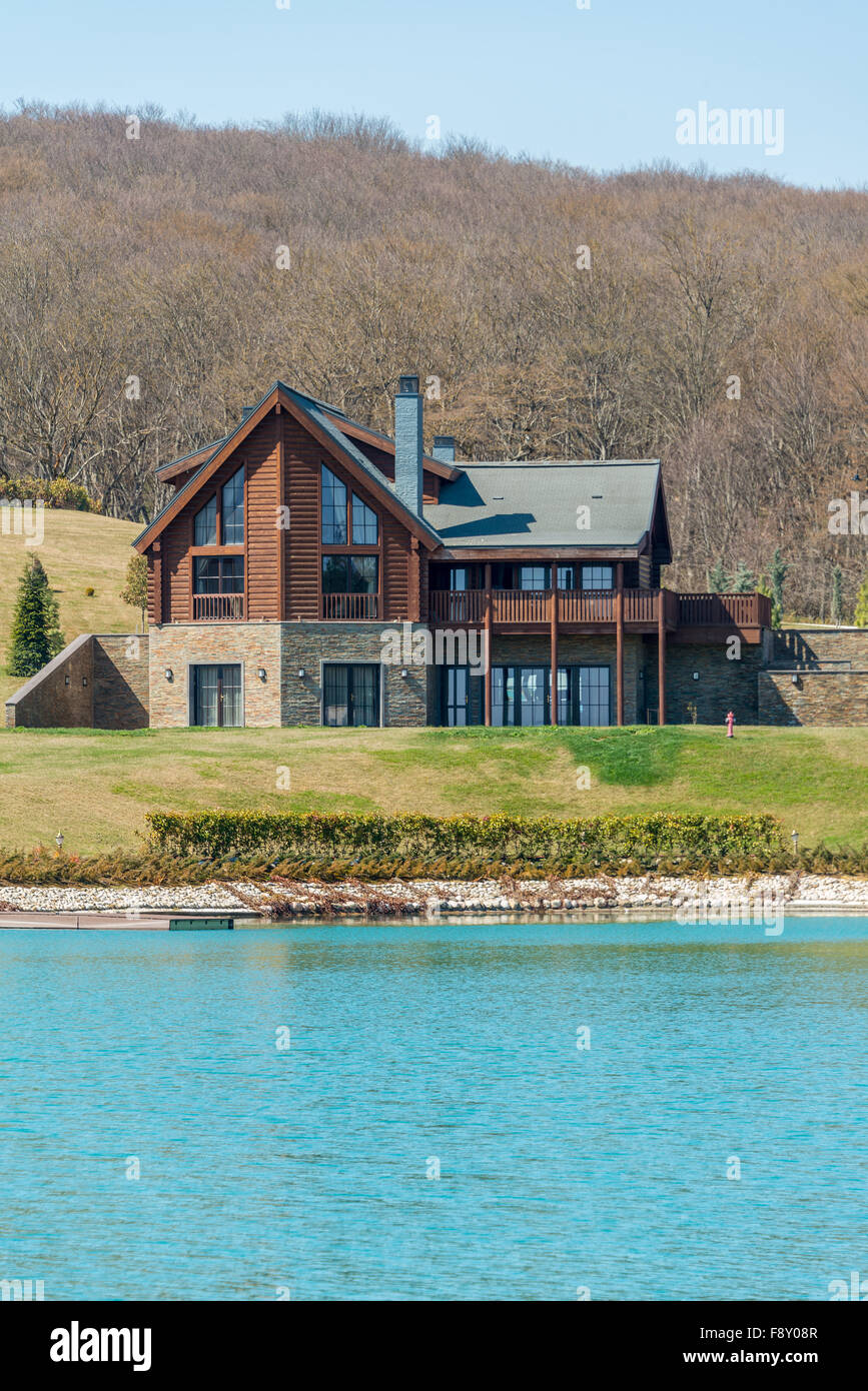 Modern house near water on bright day Stock Photo - Alamy