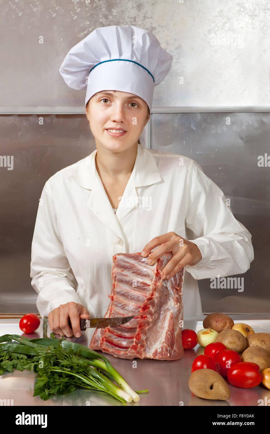 Cook woman cooking meat in kitchen Stock Photo - Alamy