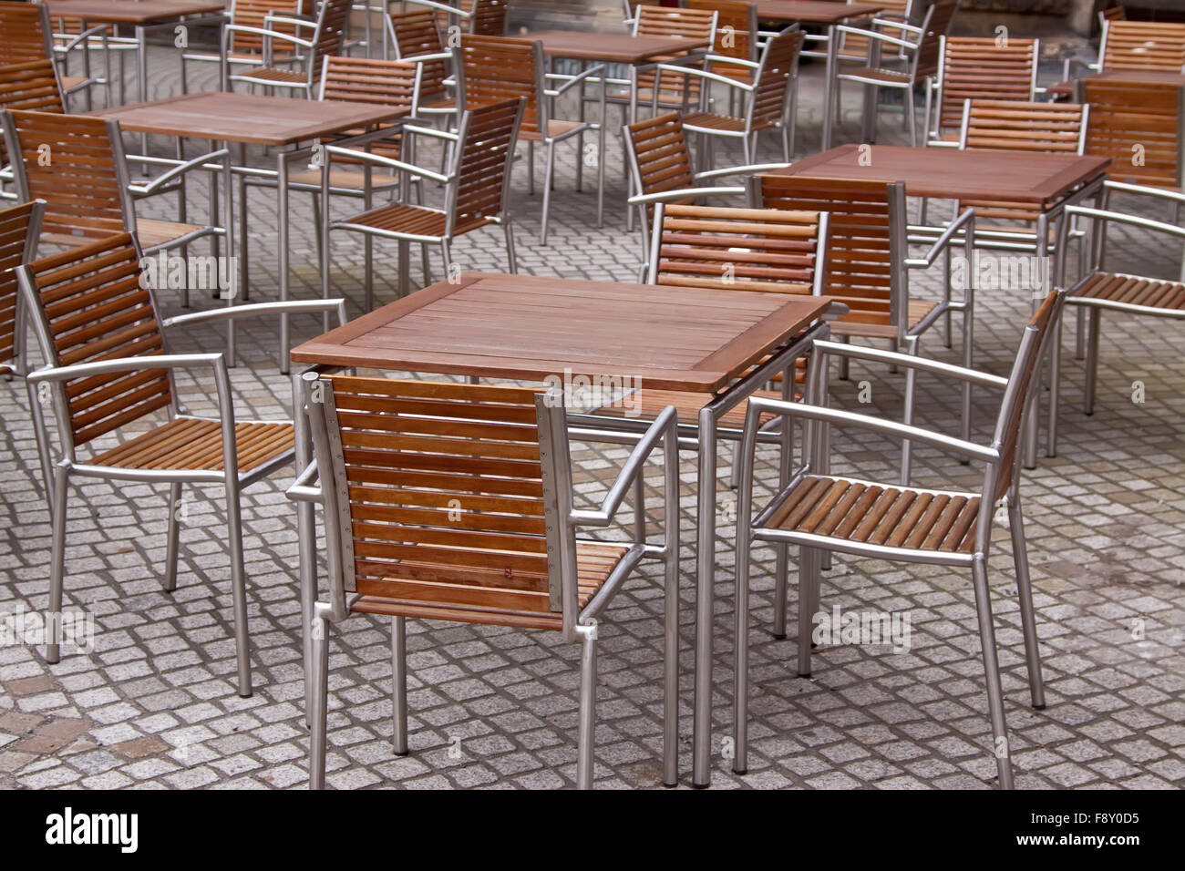 Street cafe with wooden tables and chair Stock Photo - Alamy