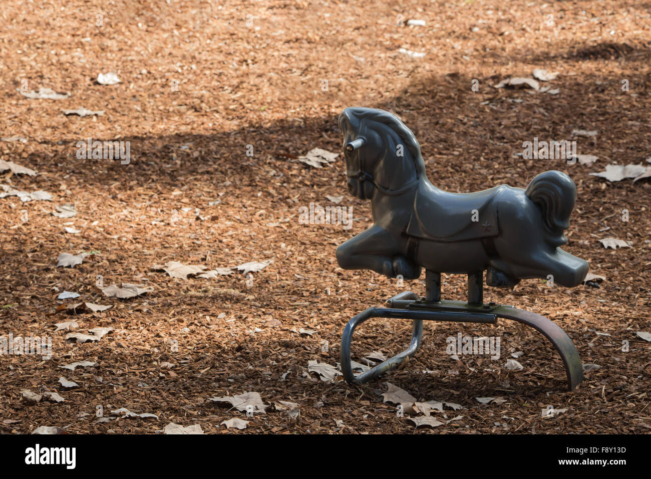 A gray horse toy at the playground Stock Photo - Alamy