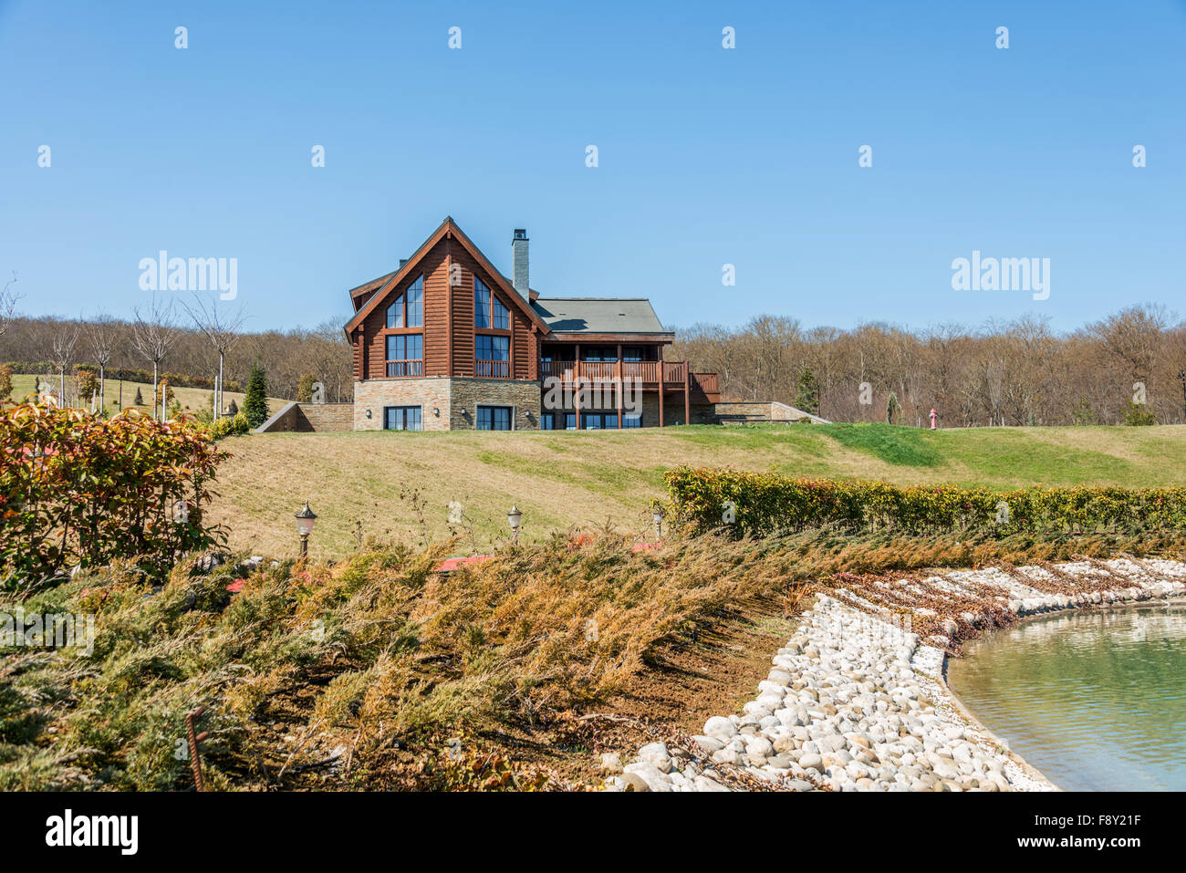 Modern house near water on bright day Stock Photo - Alamy