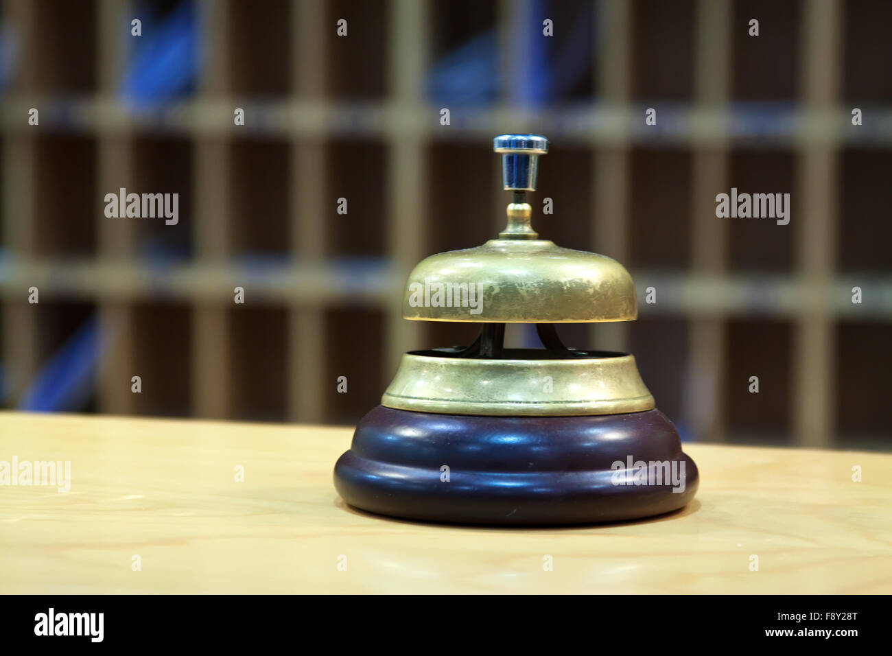 Golden bell on reception desk in hotel Stock Photo - Alamy