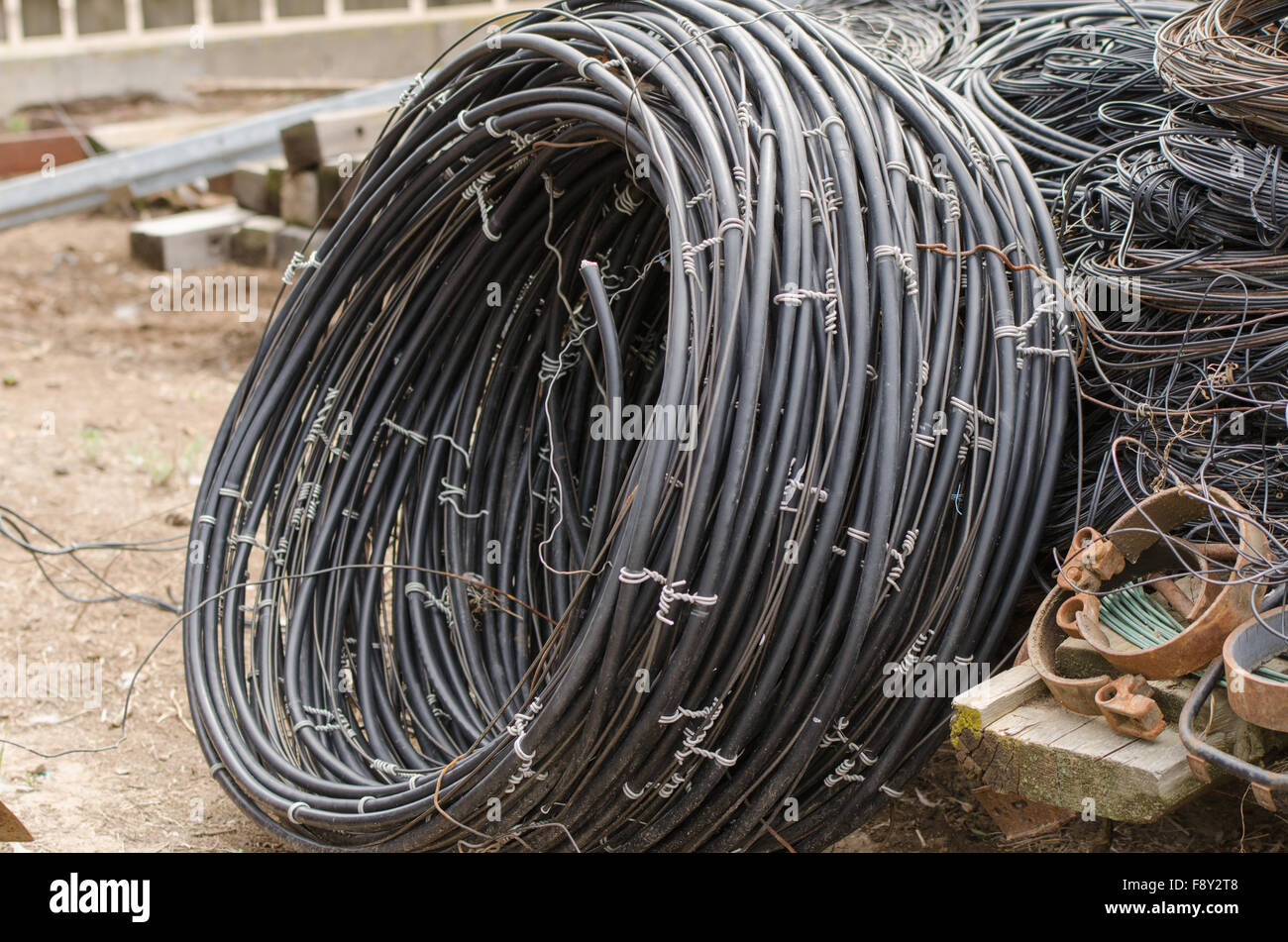 pile of old electrical high-voltage wires lying on the ground Stock ...