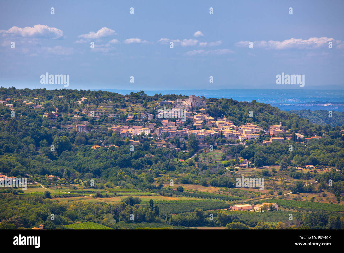 Landscape with a Castle ruins on a hill above the village in Provence ...