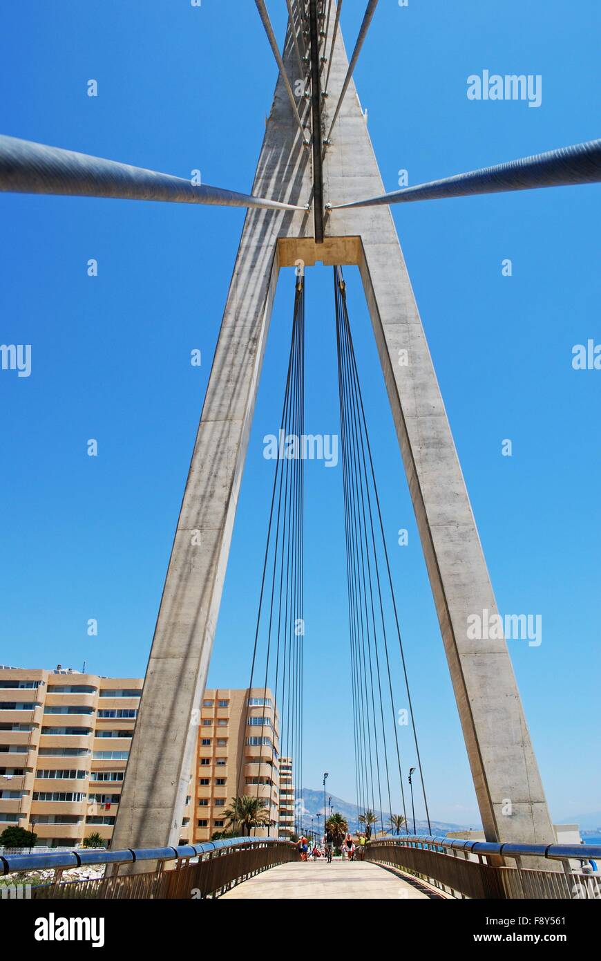 Modern footbridge across the Fuengirola river alongside the beach ...