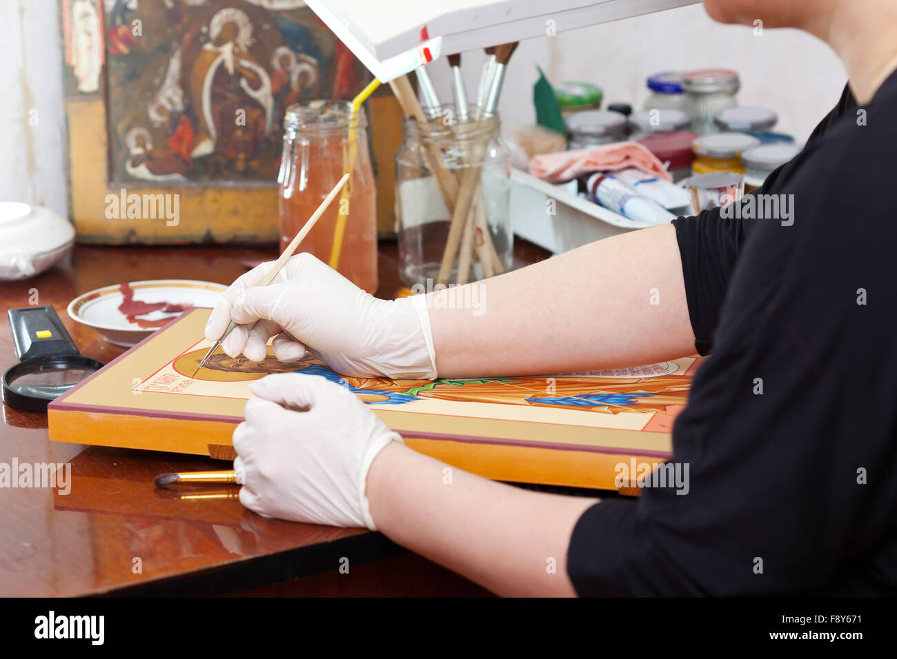 Iconographer painting of Christian icon with brush at icon-painting ...