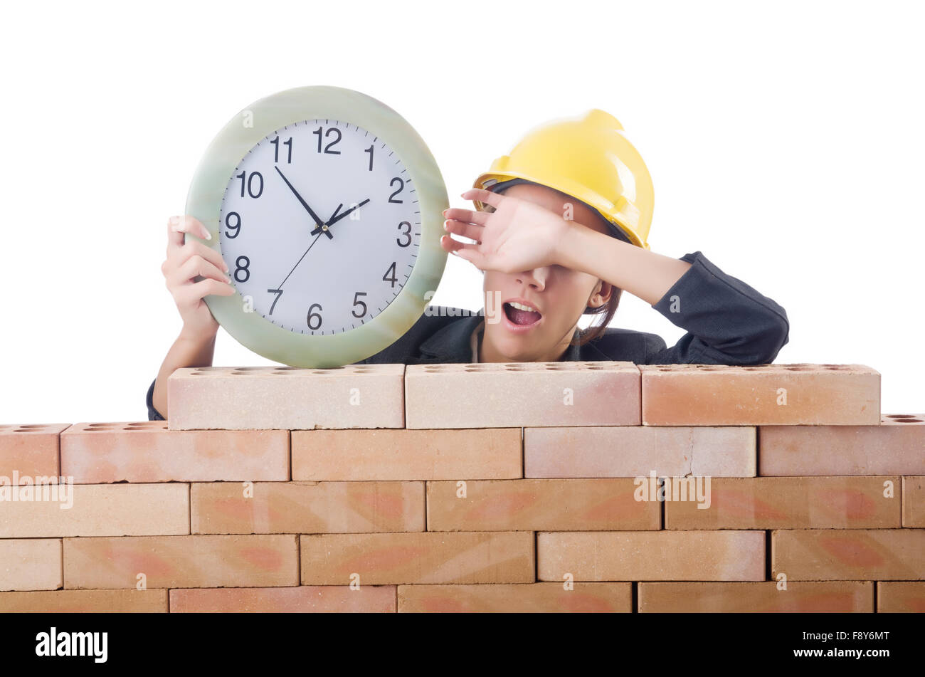 Woman construction worker with clock on white Stock Photo - Alamy
