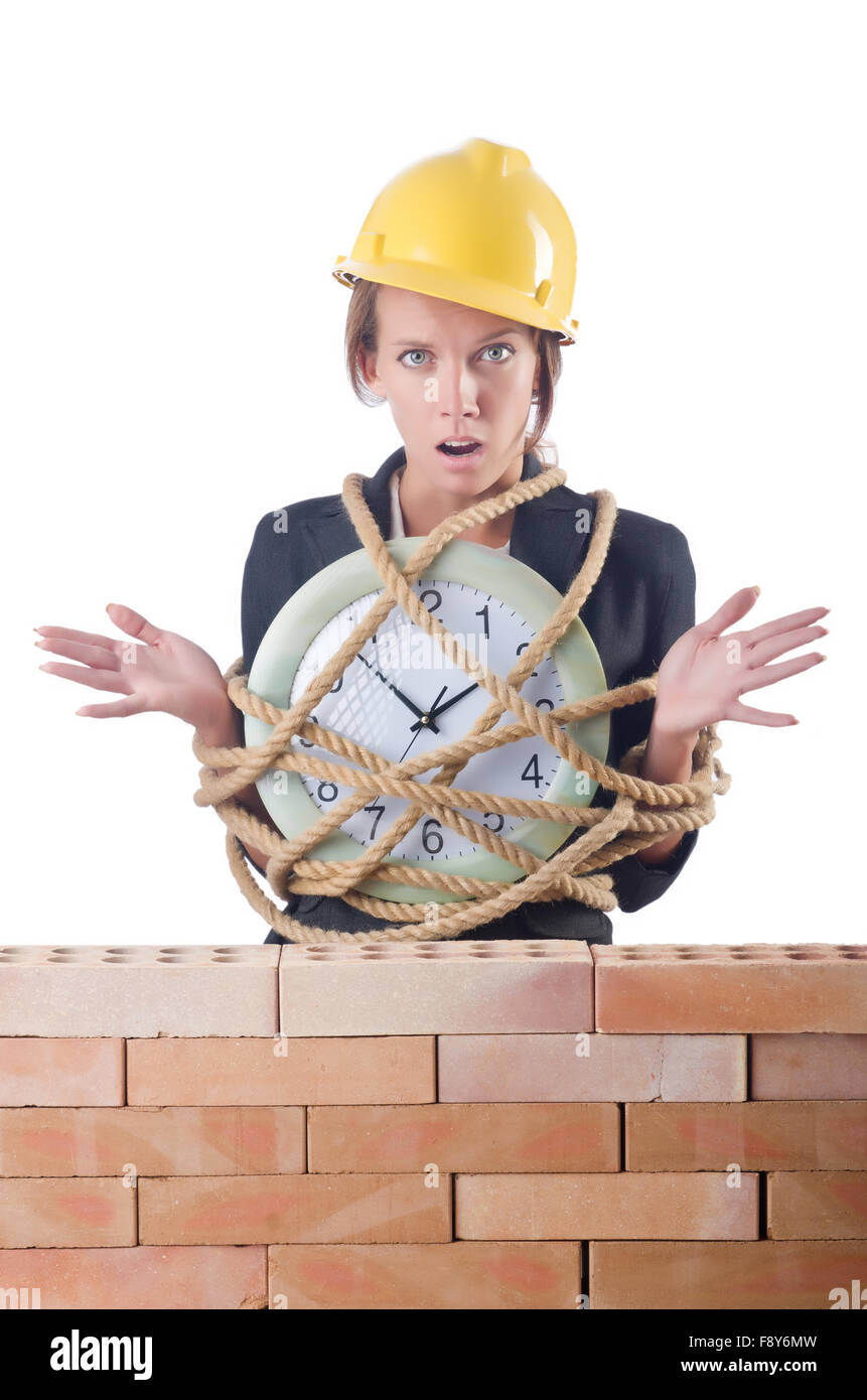 Woman construction worker with clock on white Stock Photo - Alamy