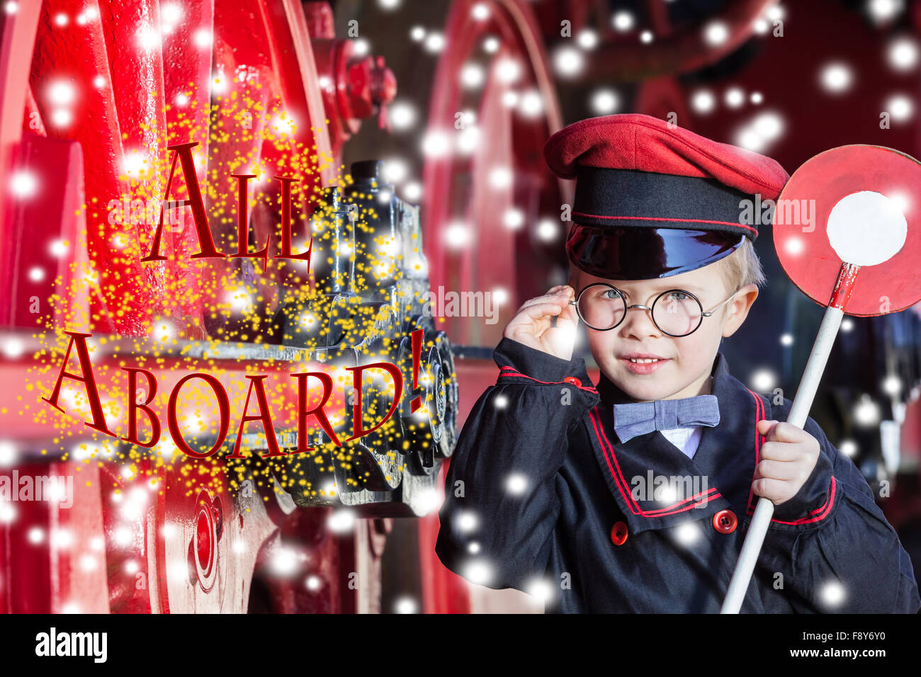 Little child boy in snowy winter as nostalgic railroad conductor beside ...