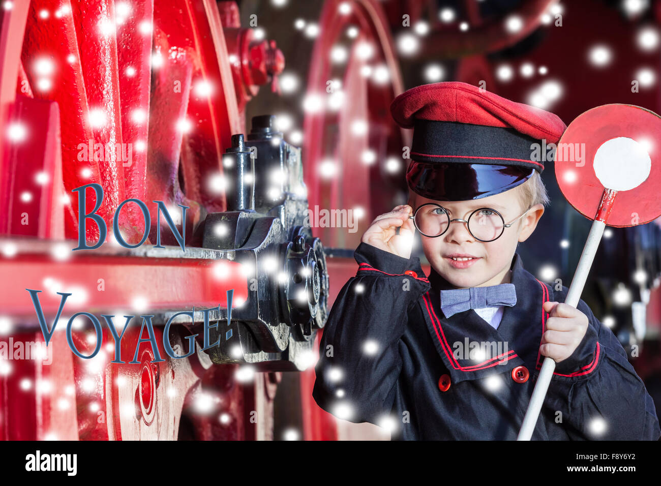Little child boy in snowy winter as nostalgic railroad conductor beside ...