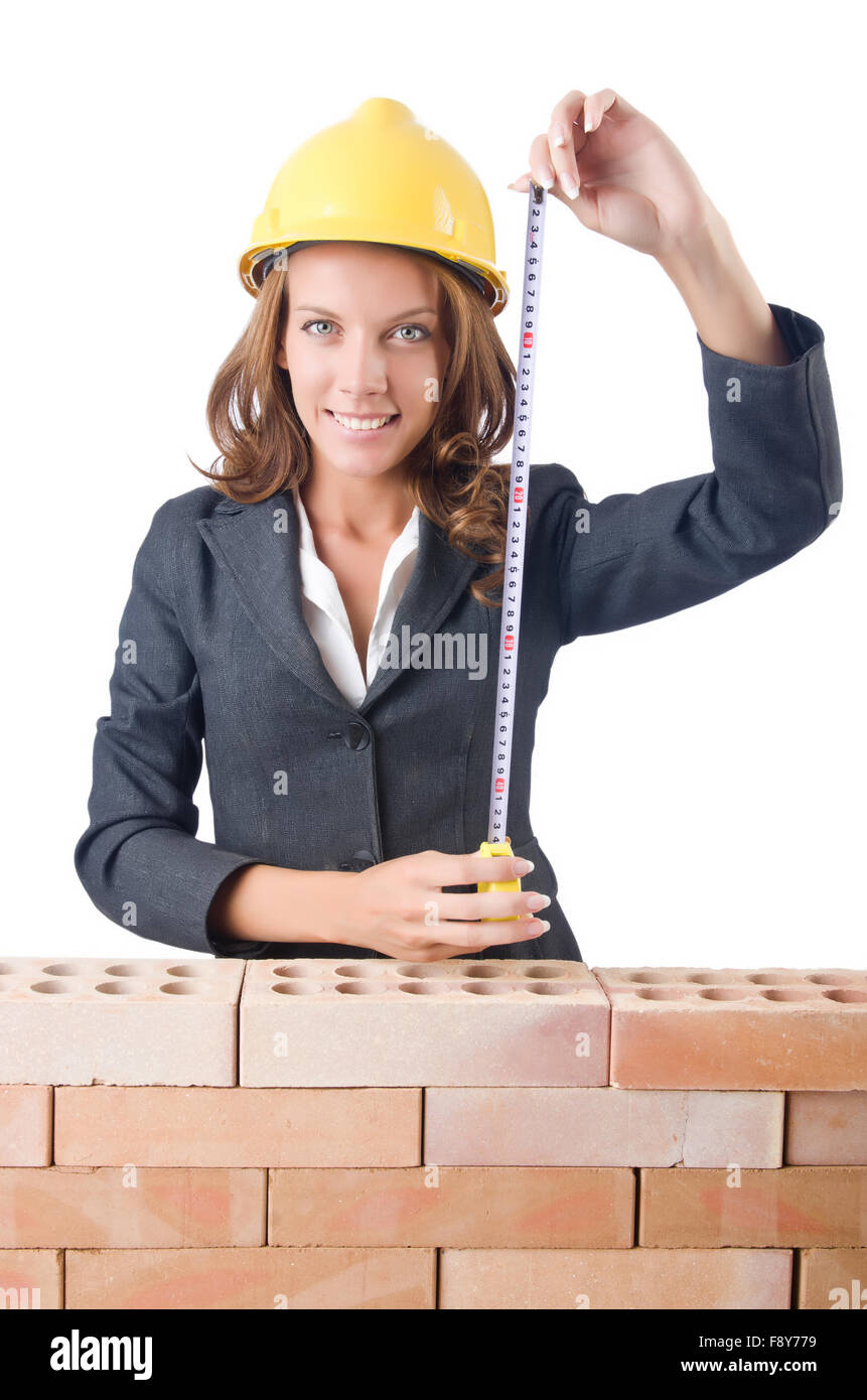 Woman builder measuring isolated on the white Stock Photo - Alamy