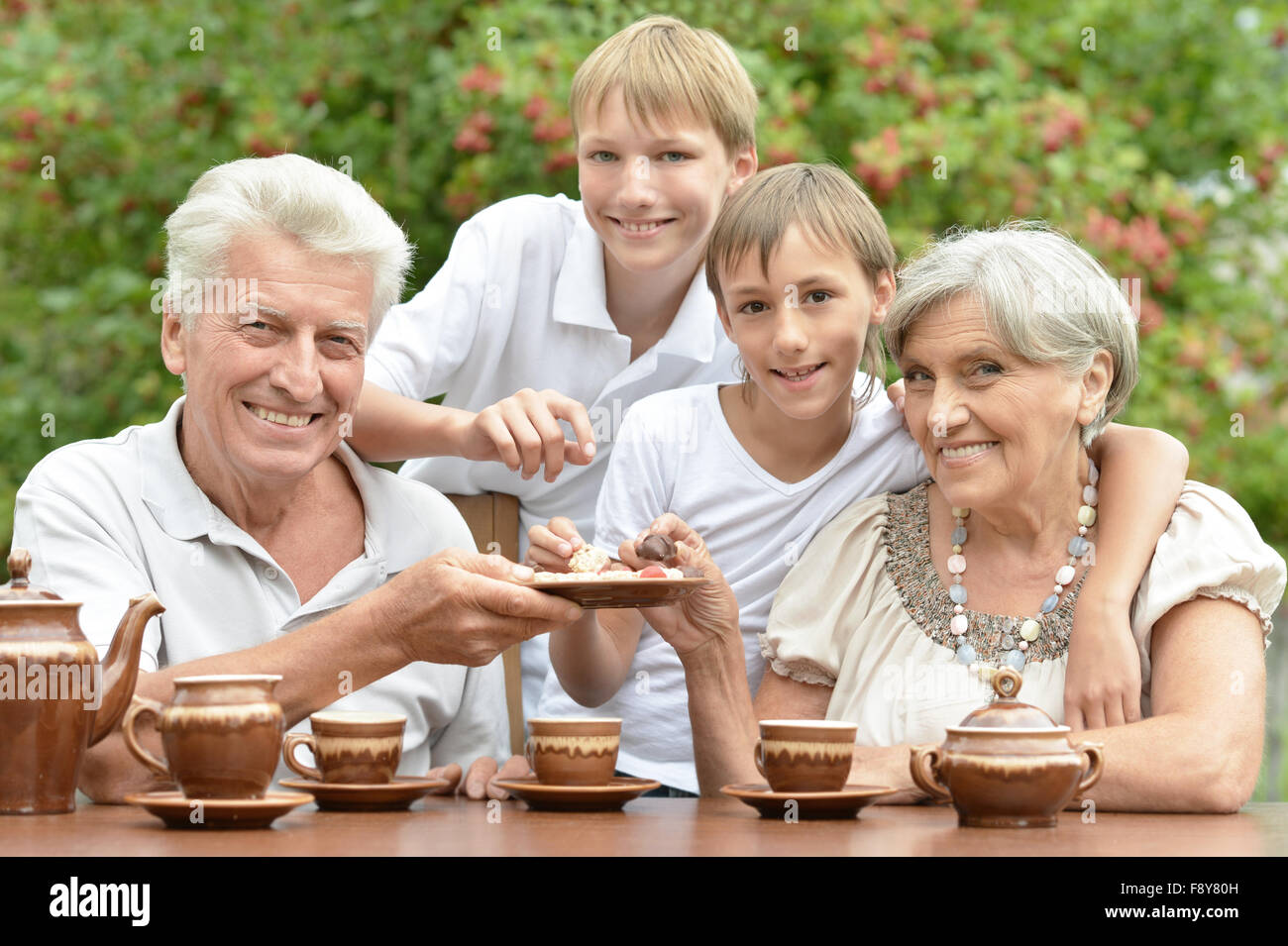 Family drinking tea in garden Stock Photo - Alamy