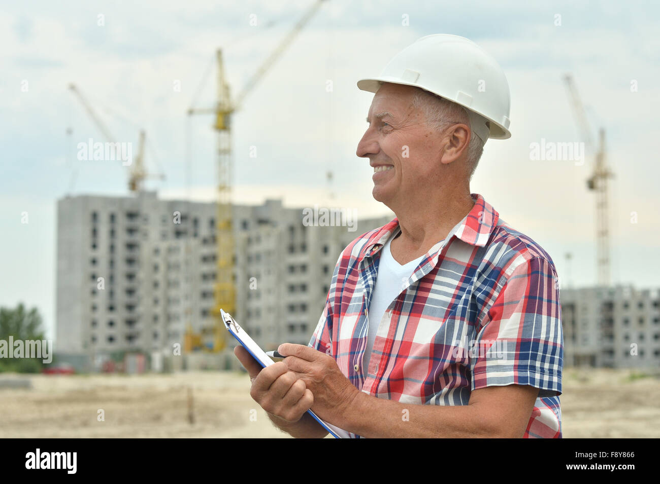 Senior man in under construction Stock Photo - Alamy
