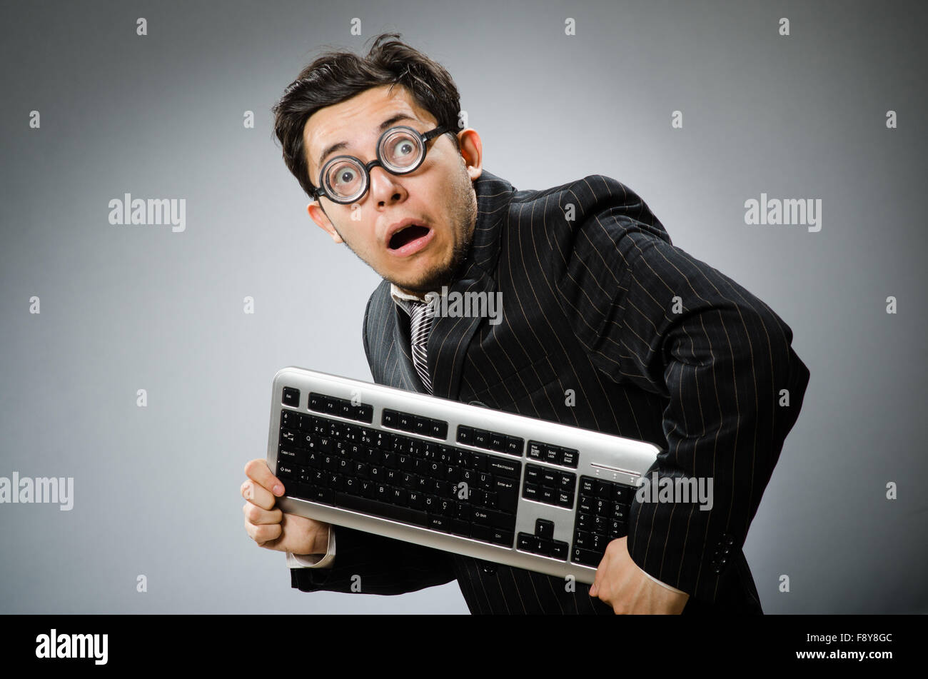 Comouter geek with computer keyboard Stock Photo - Alamy