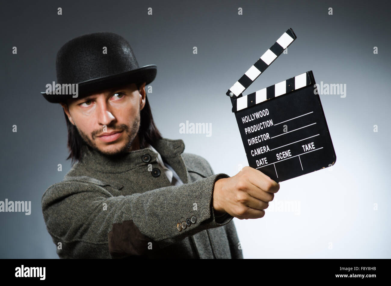 Man with movie clapperboard and hat Stock Photo - Alamy