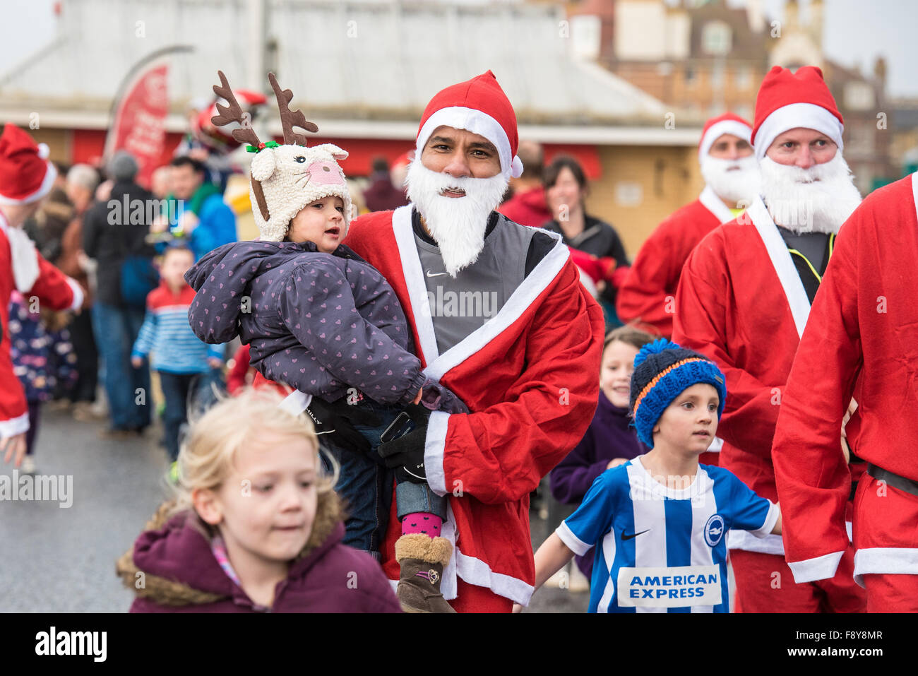 Brighton, East Sussex, UK. 12th December, 2015. Children and parents take part in the Santa Dash ...