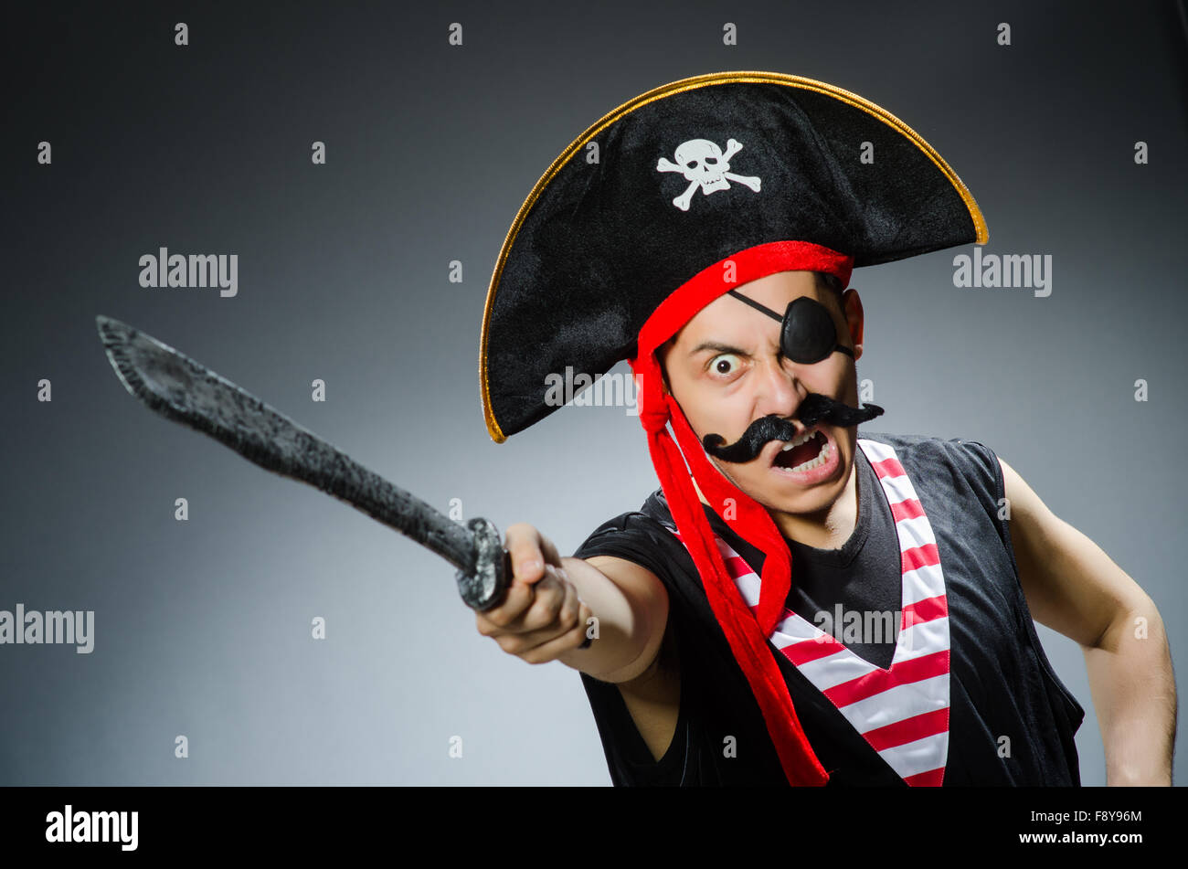 Funny pirate in the dark studio Stock Photo - Alamy