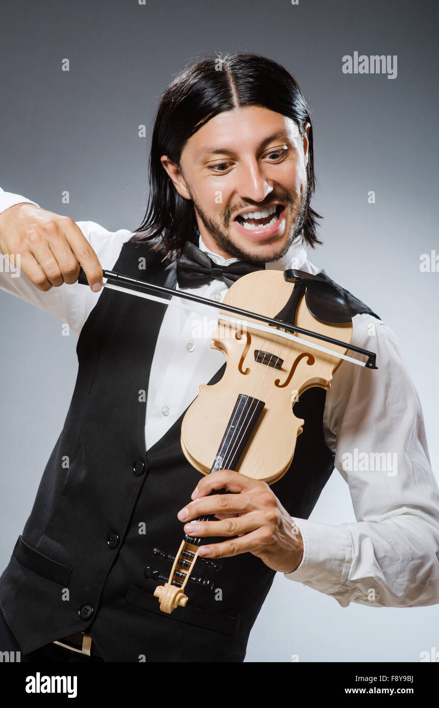 Funny fiddle violin player in musical concept Stock Photo - Alamy