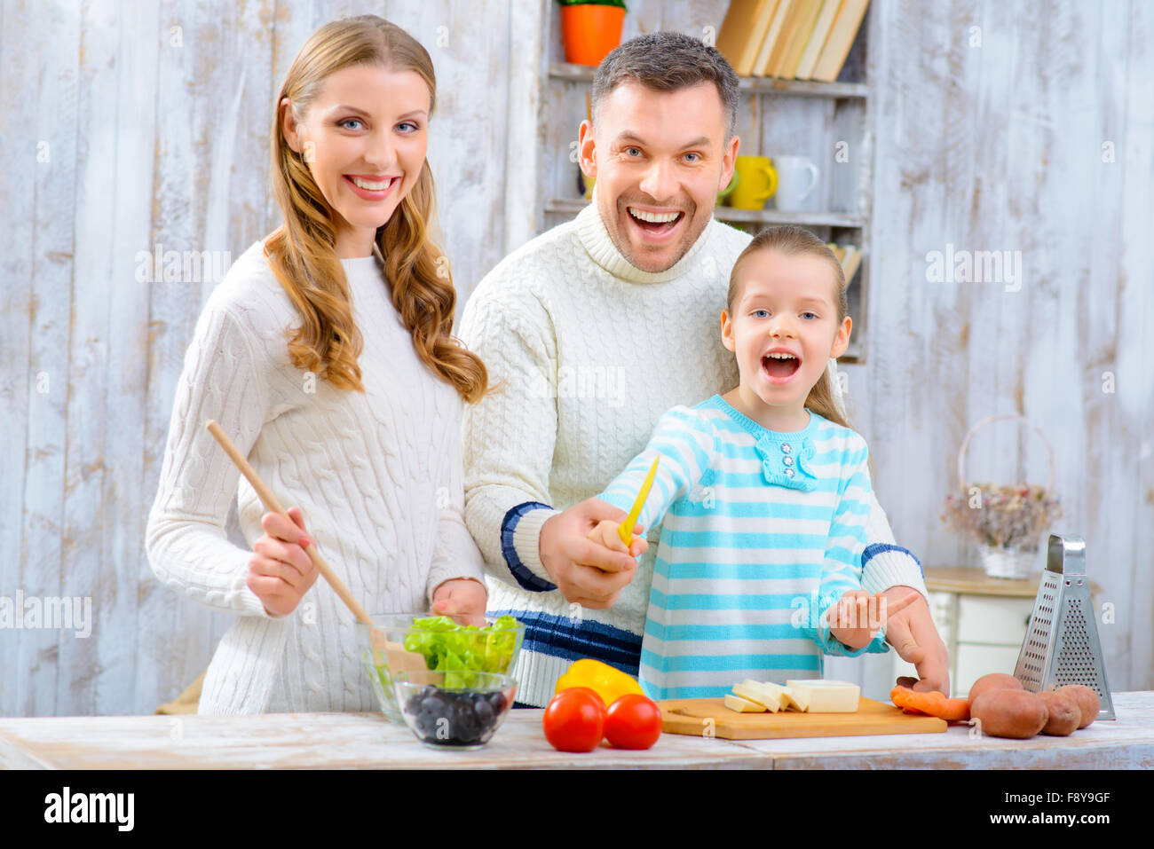 Happy family cooking together Stock Photo - Alamy