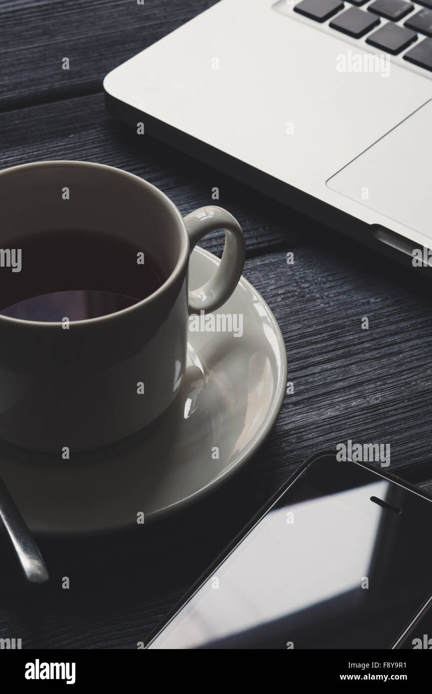 Office table with notepad, computer and tea cup Stock Photo - Alamy