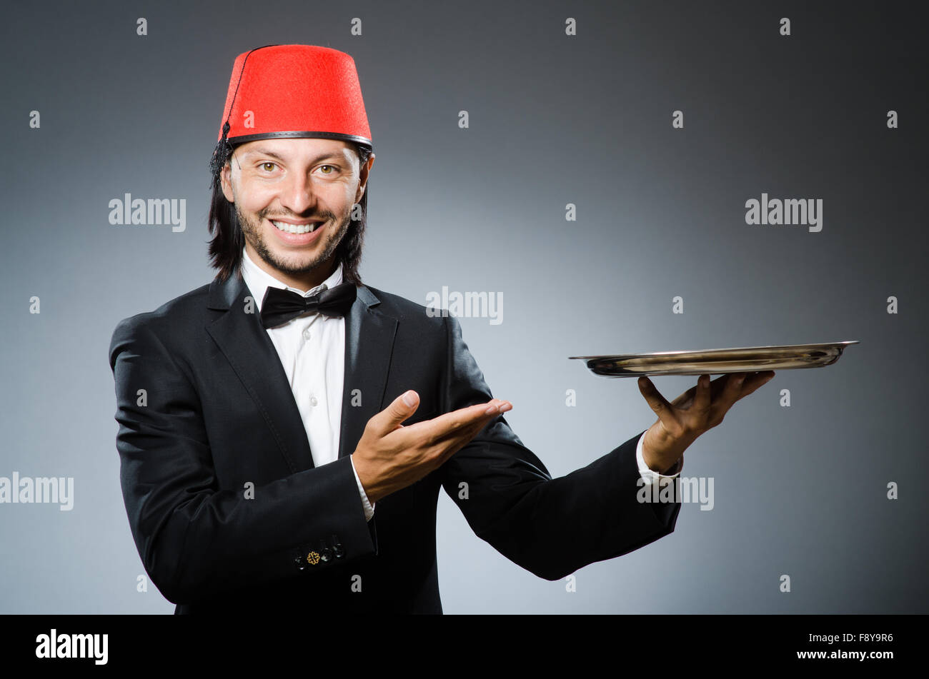Waiter wearing traditional turkish hat Stock Photo - Alamy