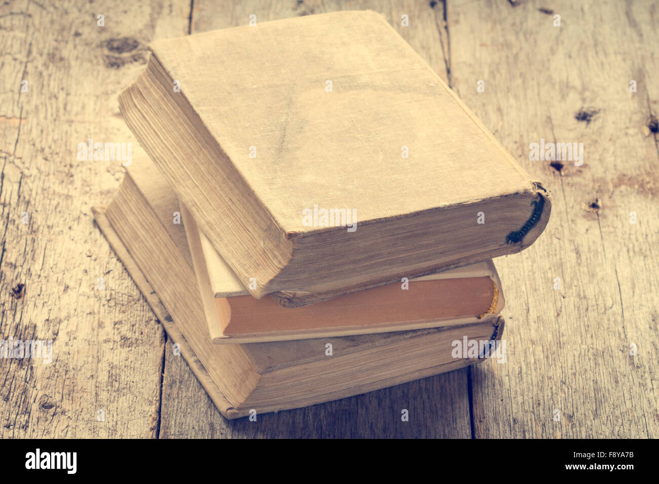 Old books on wooden background in vintage tone color Stock Photo - Alamy
