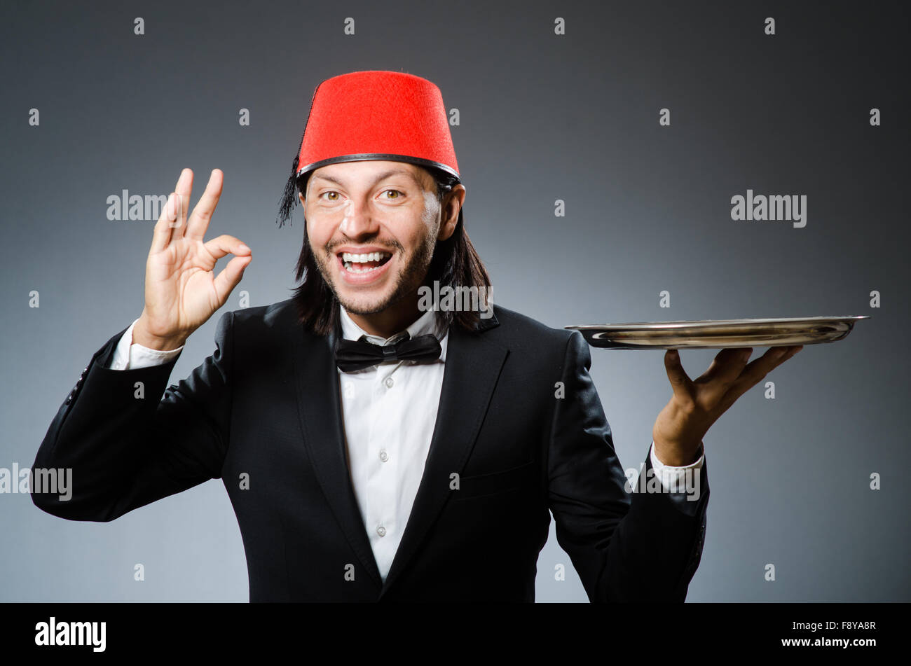 Waiter wearing traditional turkish hat Stock Photo - Alamy