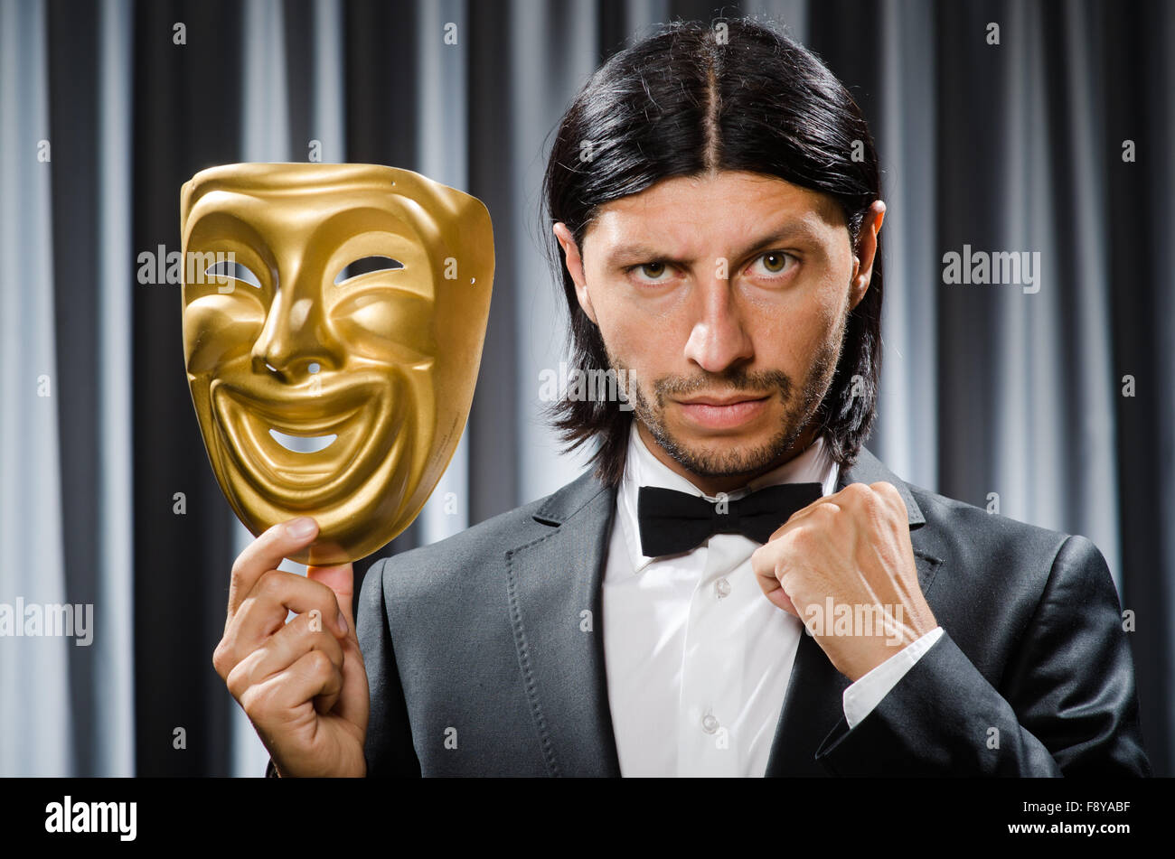 Funny concept with theatrical mask Stock Photo - Alamy