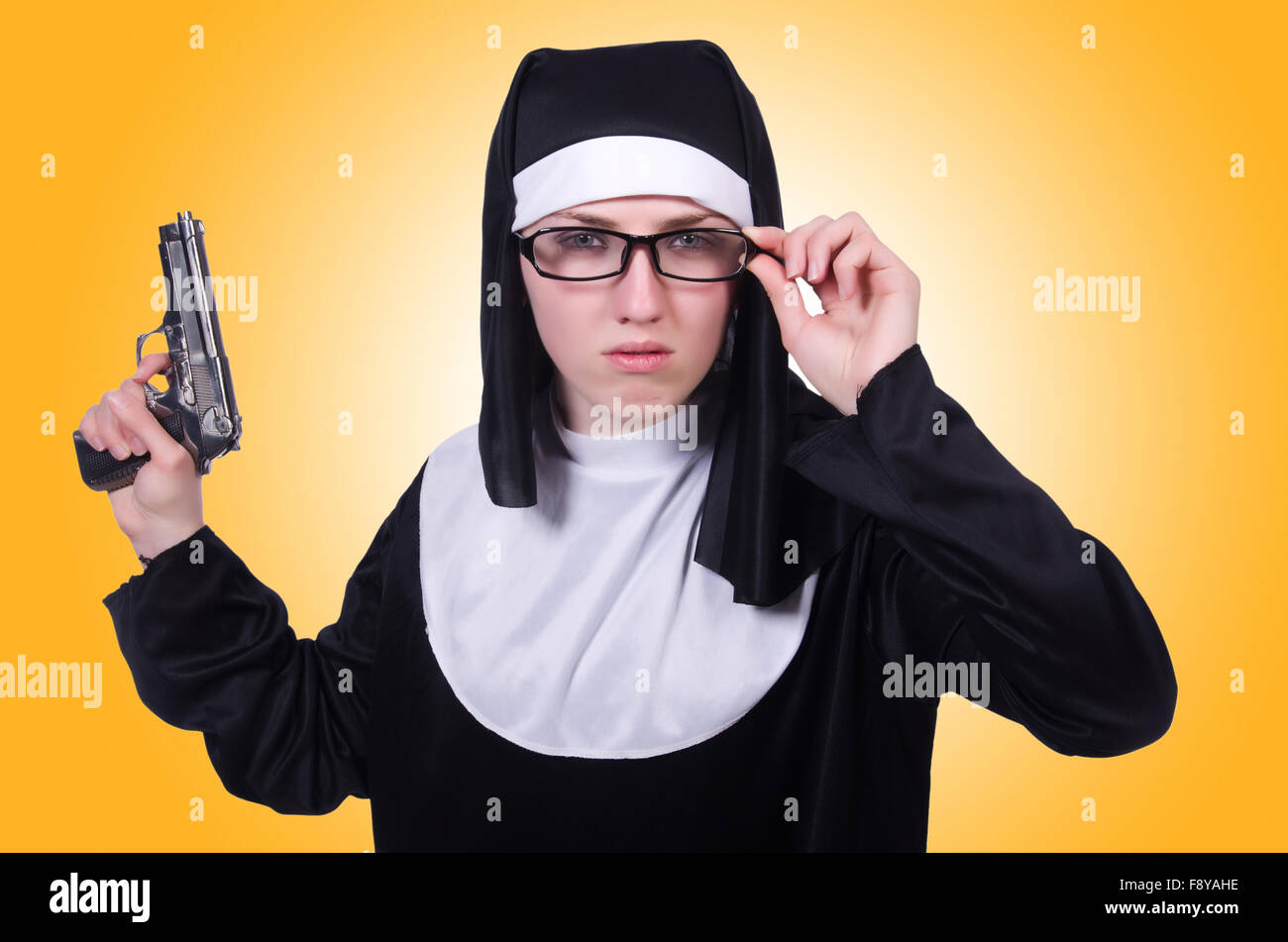 Nun with handgun isolated on white Stock Photo - Alamy