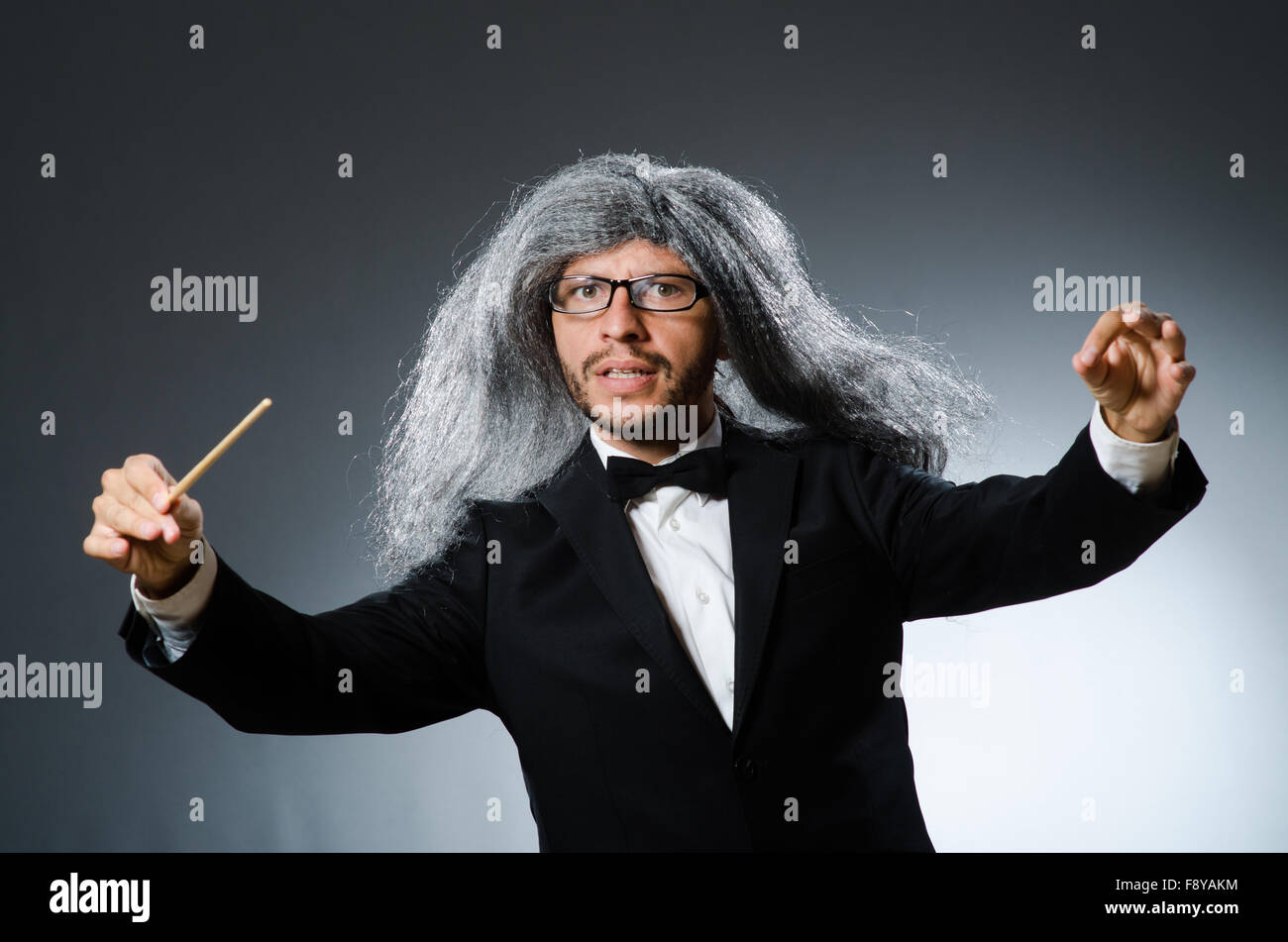 Funny conductor with long grey hair Stock Photo - Alamy