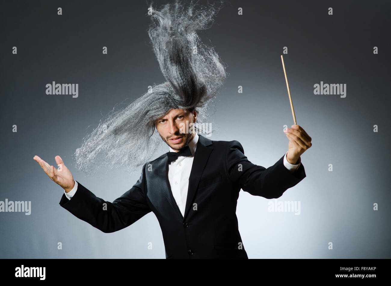 Funny conductor with long grey hair Stock Photo - Alamy
