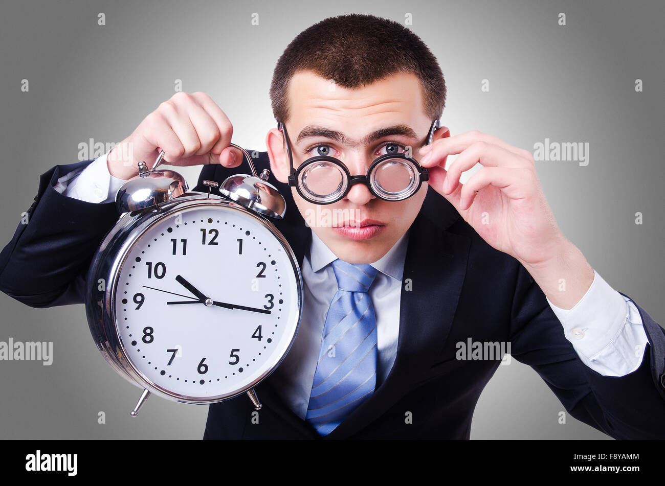 Businessman with clock isolated on white Stock Photo - Alamy
