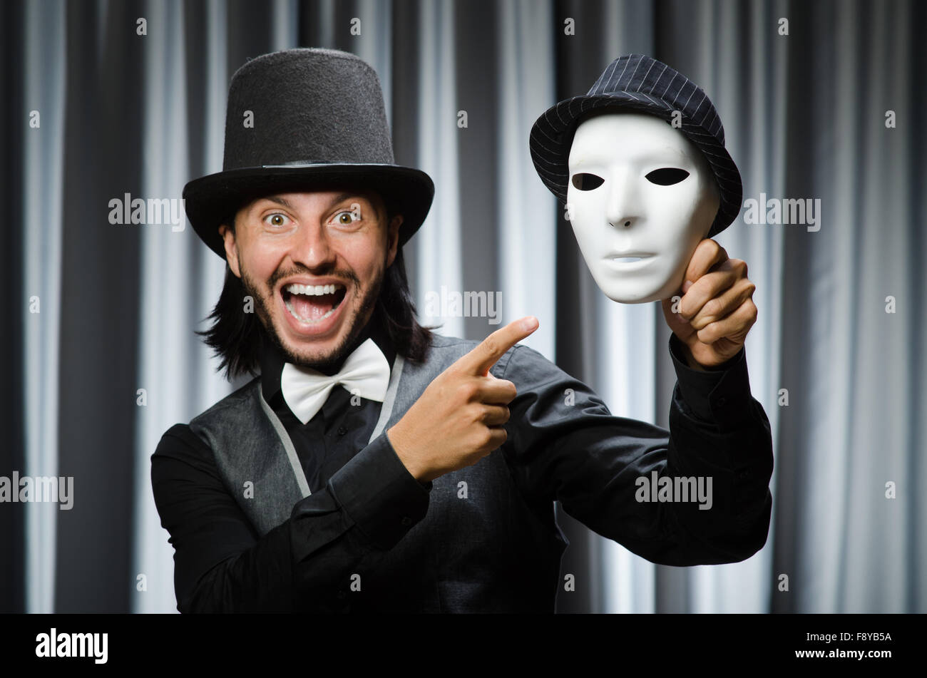 Funny concept with theatrical mask Stock Photo - Alamy