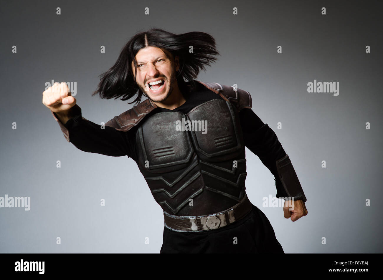 Angry warrior against dark background Stock Photo - Alamy