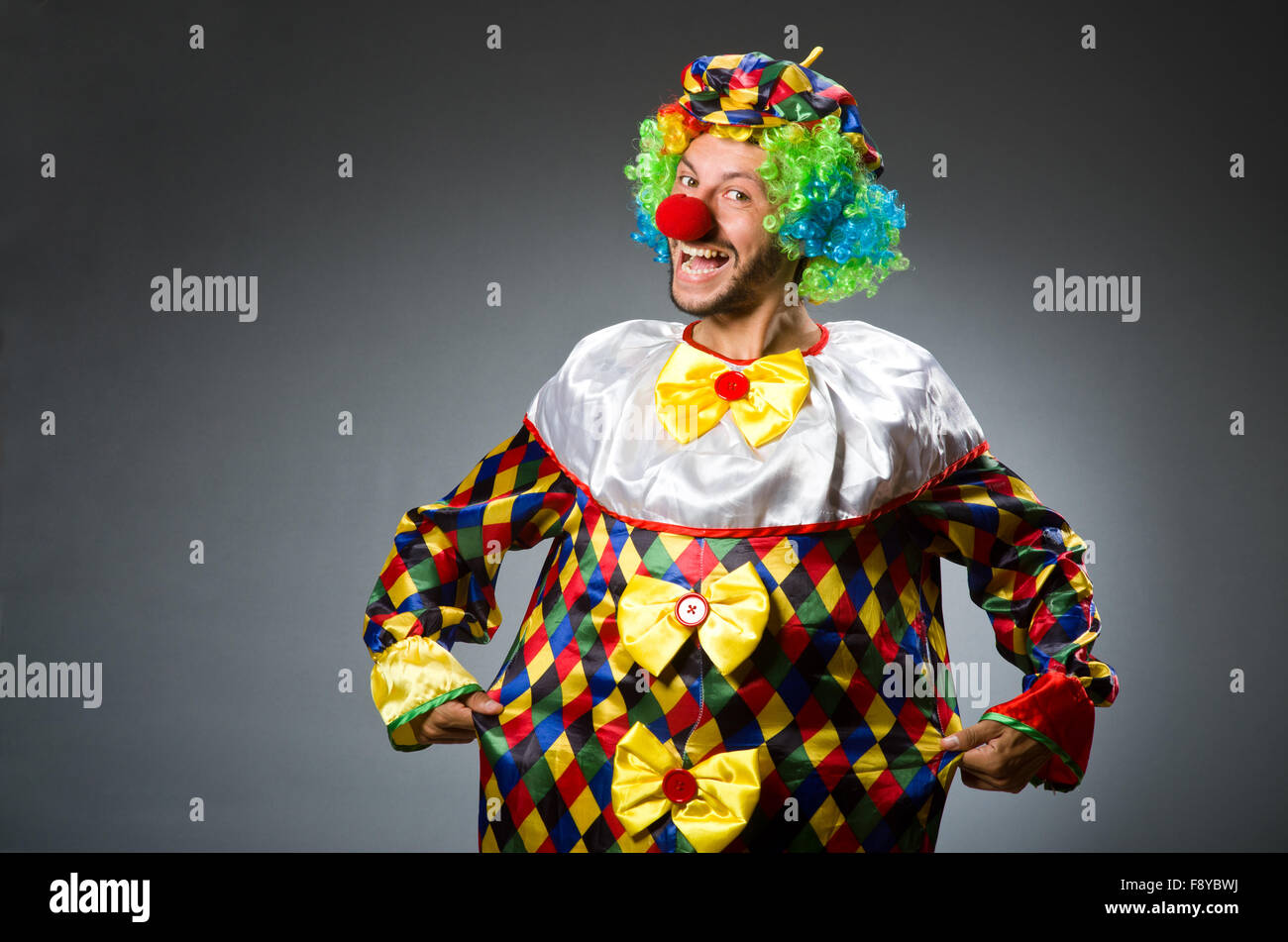 Funny clown in colourful costume Stock Photo - Alamy