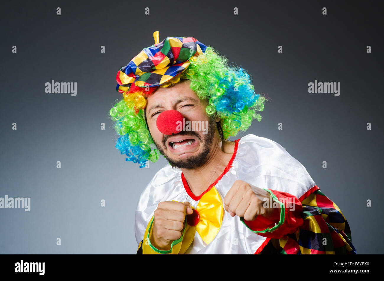 Funny clown in colourful costume Stock Photo - Alamy