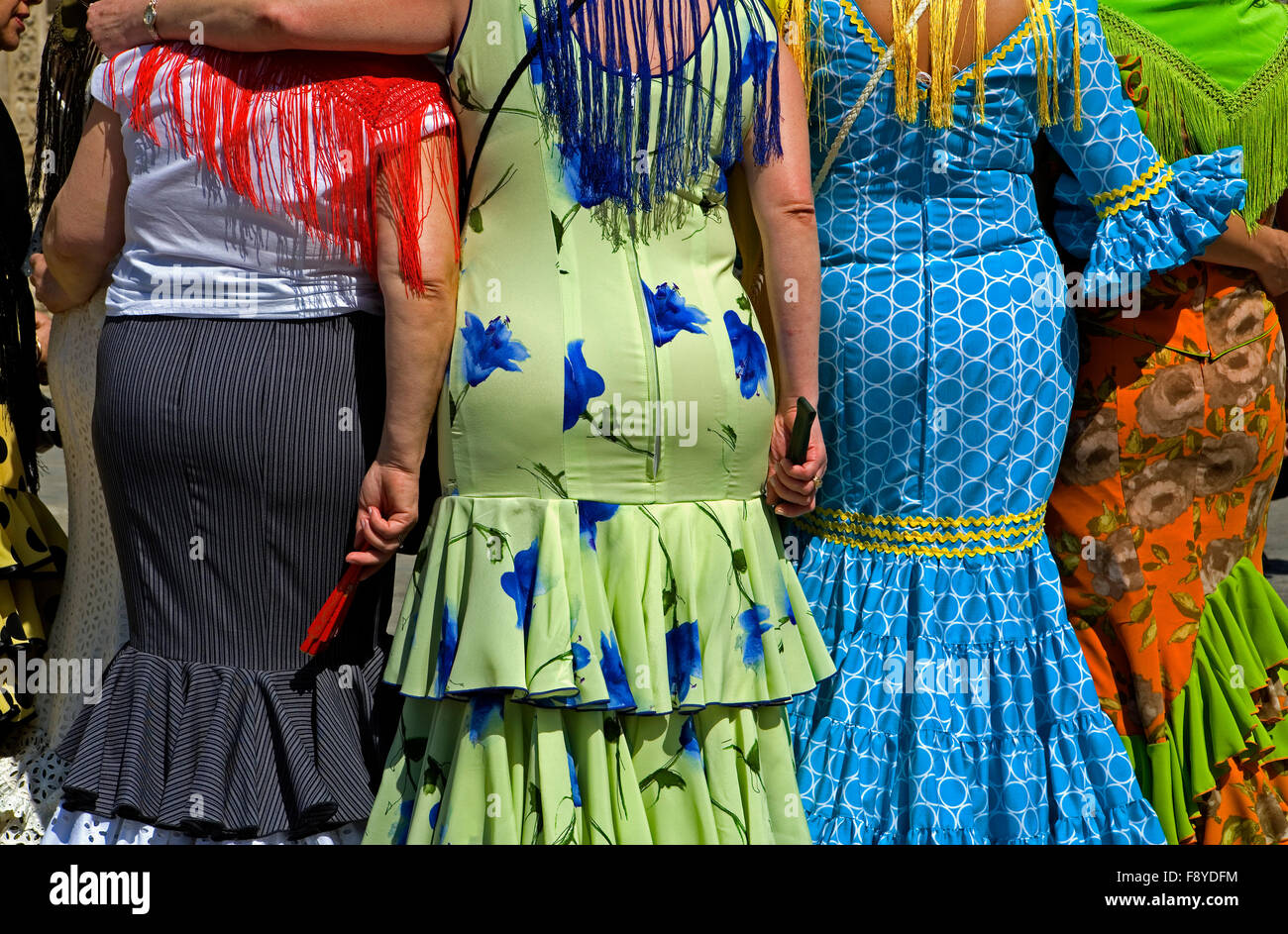 Feria de Abril (The April Fair). "El Real". Women wearing traditional ...
