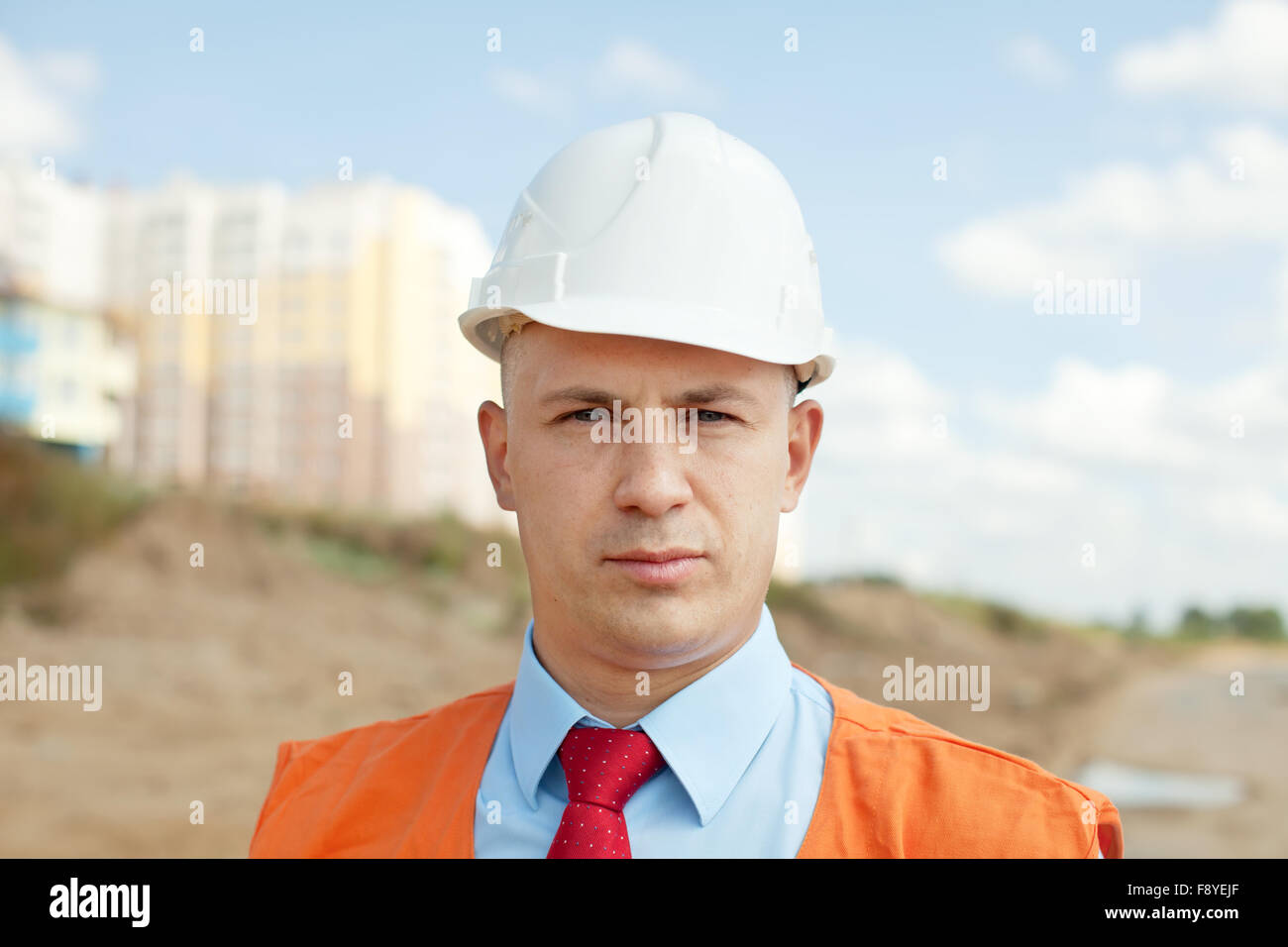 Portrait of builder works at construction site Stock Photo - Alamy