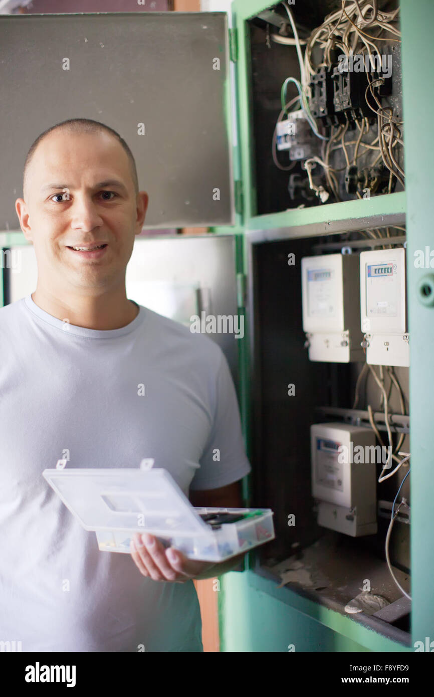 Man working with electric box at house Stock Photo - Alamy