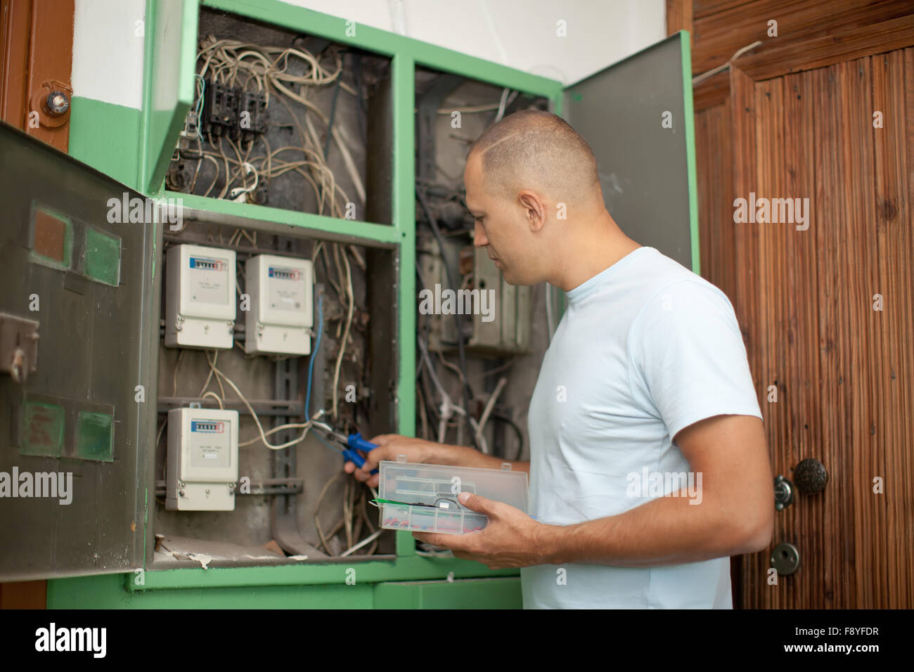 electrician working with electric box at house Stock Photo - Alamy